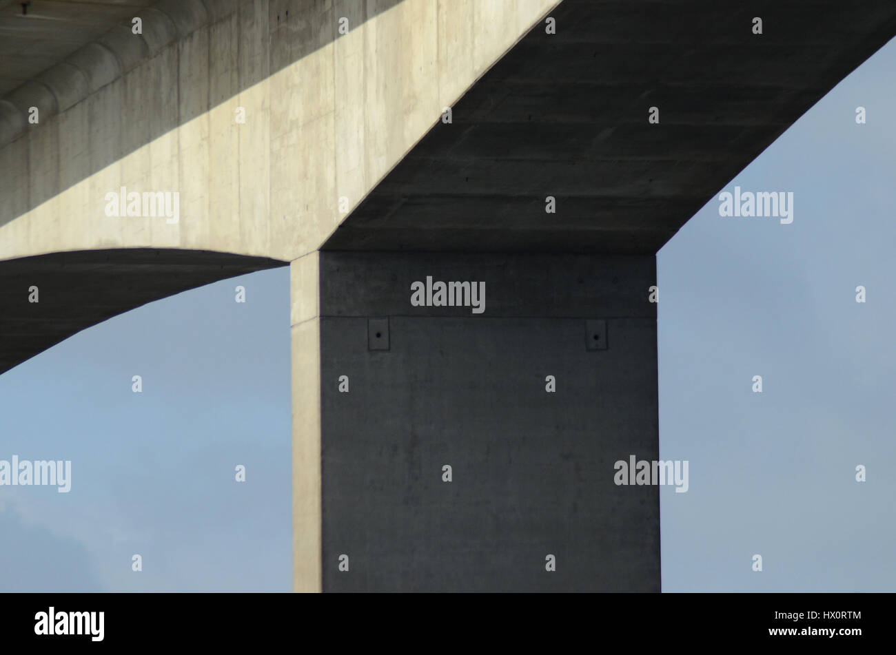 The closeup on the shapes of a concrete bridge makes up an abstract ...