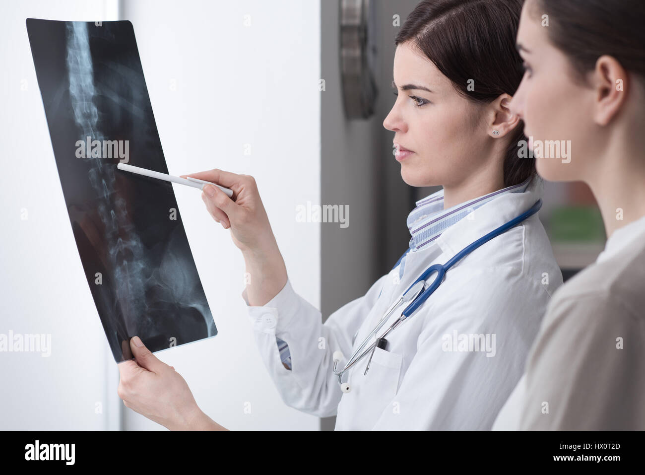 Professional doctor examining a patient's x-ray and pointing, medical ...