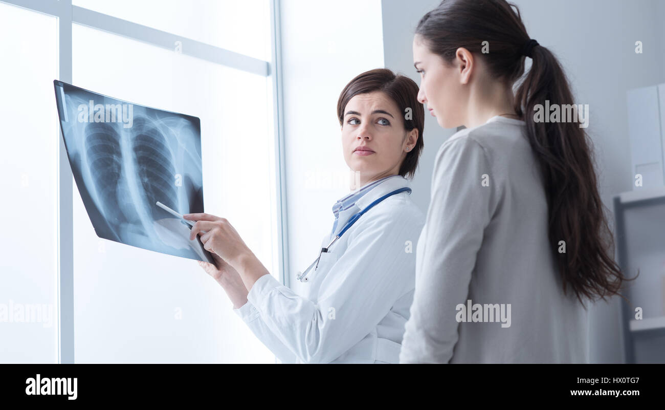 Professional doctor examining a patient's x-ray and pointing, medical ...