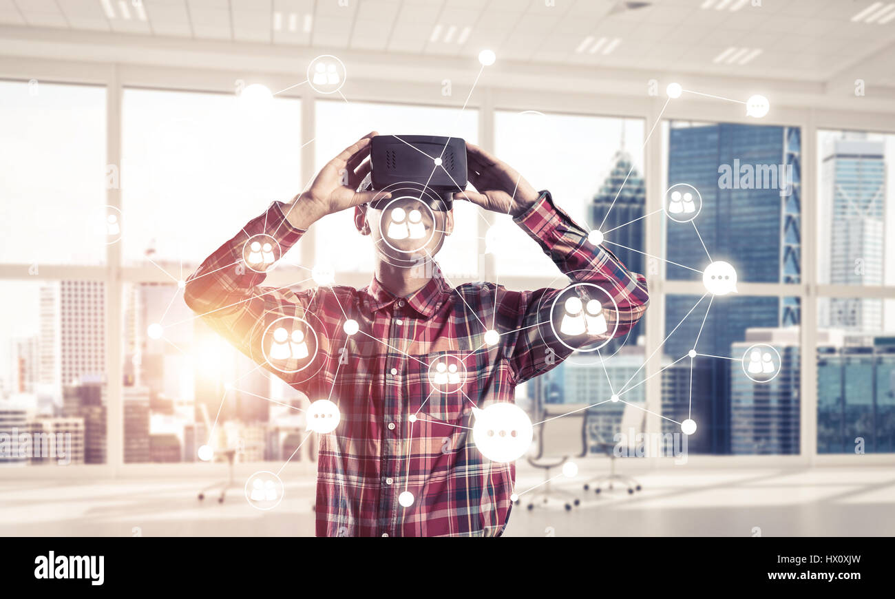 Guy wearing checked shirt and virtual mask demonstrating some em Stock ...