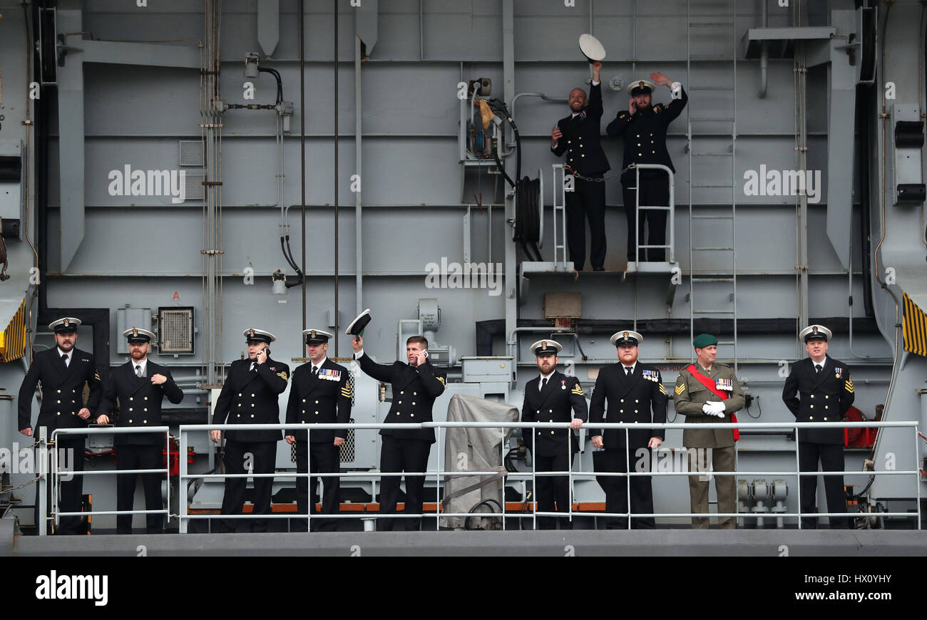Members of the crew wave to family and friends as HMS Ocean, the Royal ...