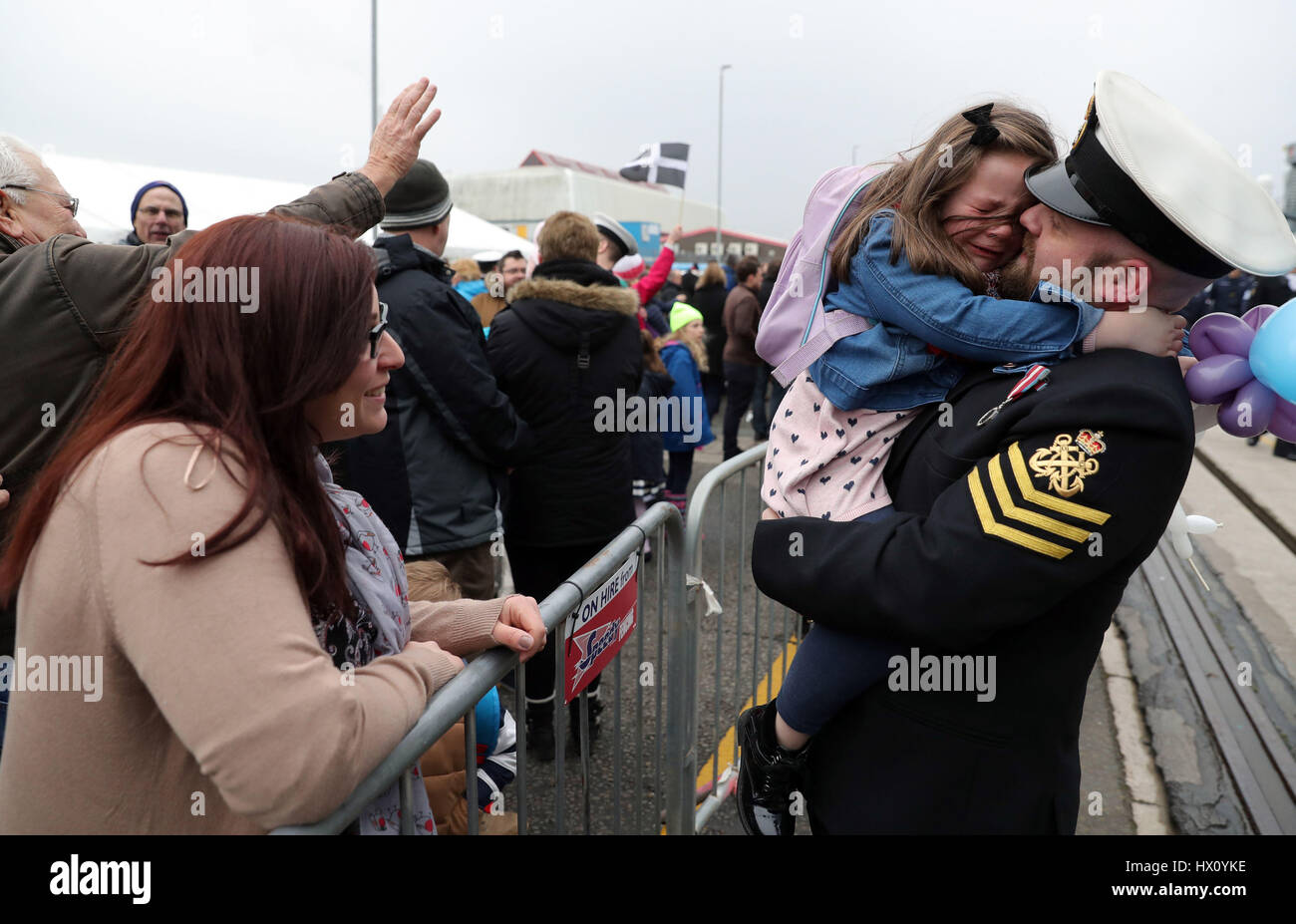 Petty Officer Adam Jeffrey (right) is greeted by his daughter Isabelle ...