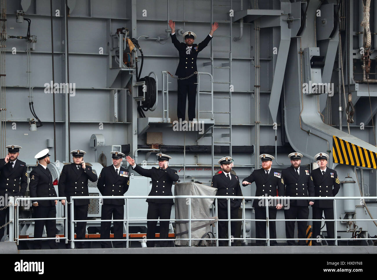 Members of the crew wave to family and friends as HMS Ocean, the Royal ...