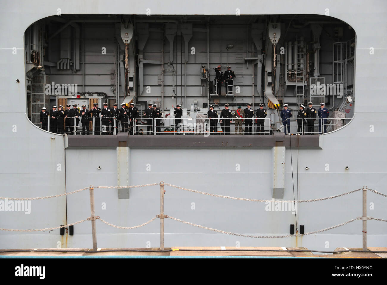 Members of the crew wave to family and friends as HMS Ocean, the Royal ...