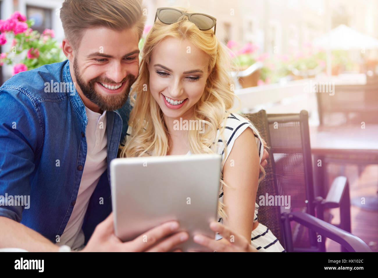 Happy couple checking menu at the tablet Stock Photo - Alamy