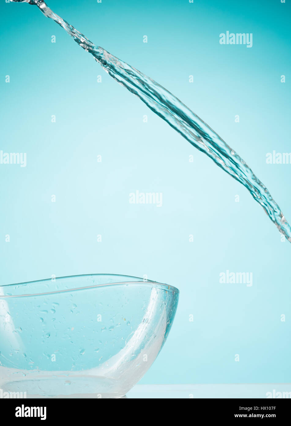 The water splashing to glass bowl on white background Stock Photo - Alamy