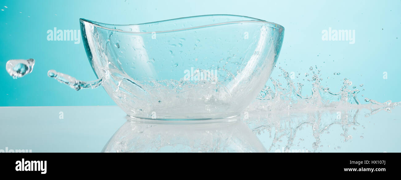 The water splashing to glass bowl on white background Stock Photo - Alamy