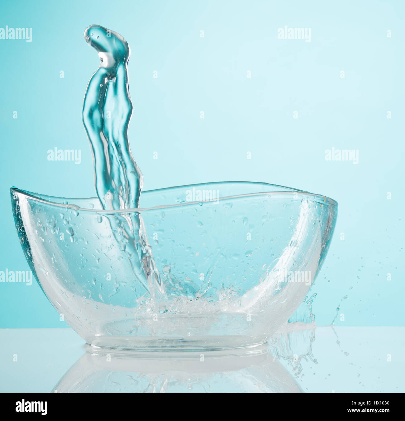 The water splashing to glass bowl on white background Stock Photo - Alamy
