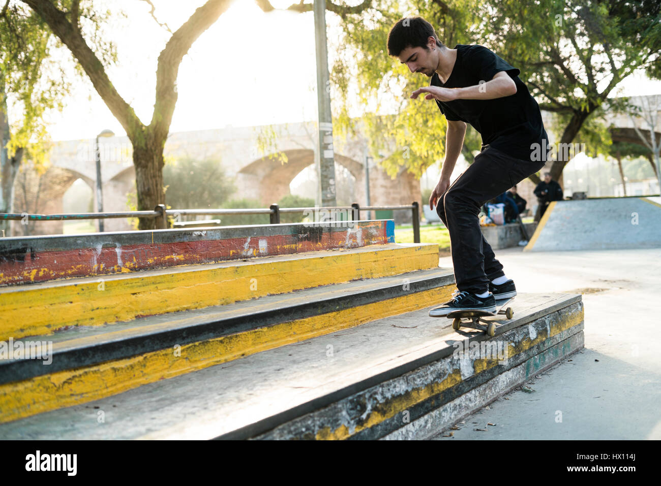 Young man riding skateboard in a skatepark Stock Photo - Alamy