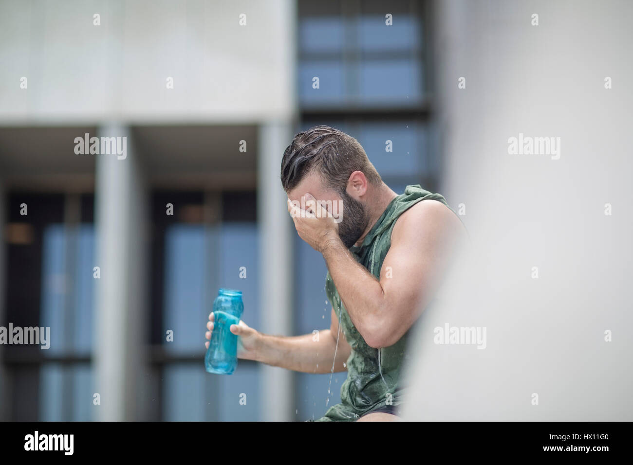Athlete taking a water break in the city Stock Photo - Alamy