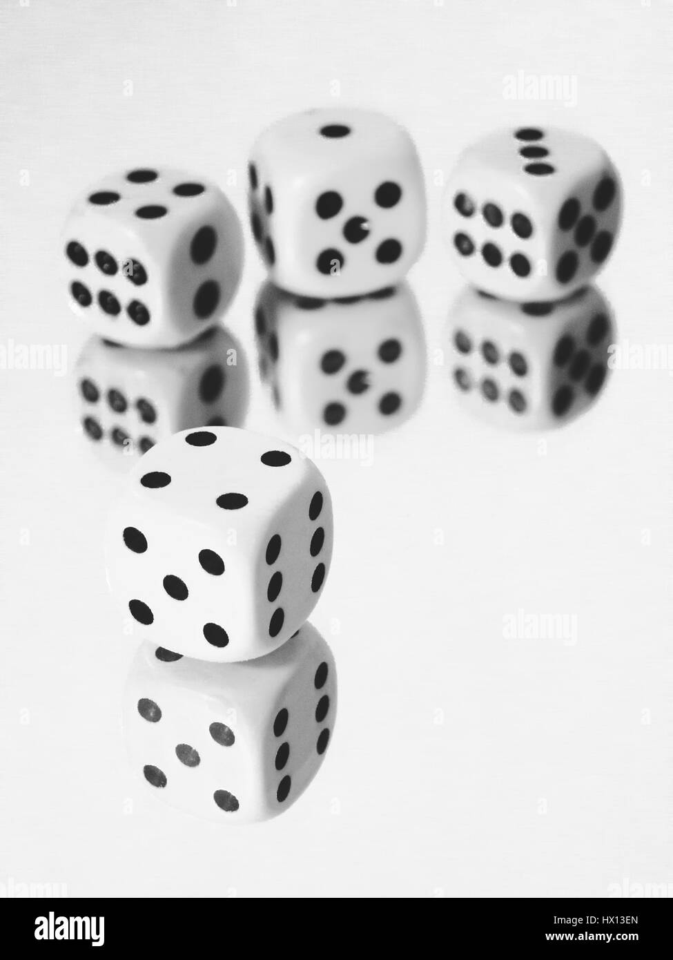 White cubic dices lying on a mirror Stock Photo - Alamy