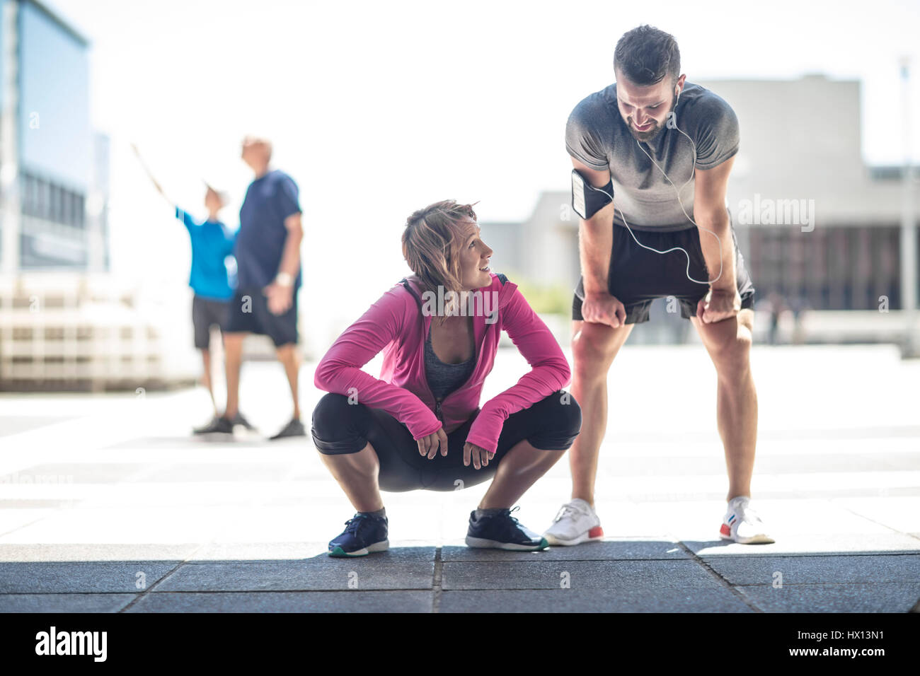 Two athletes taking a break in the city Stock Photo - Alamy