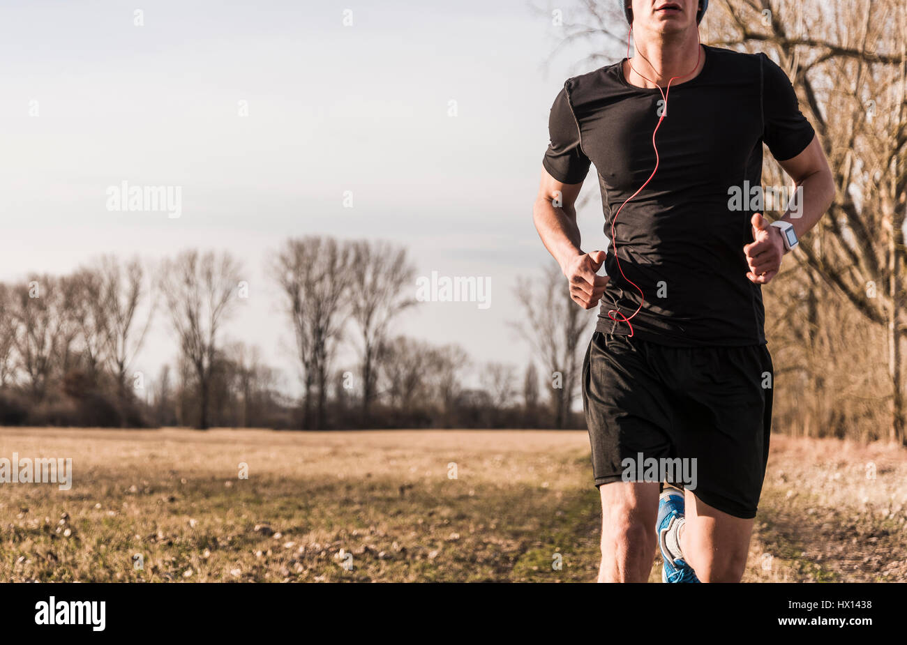 Man running in rural landscape Stock Photo - Alamy
