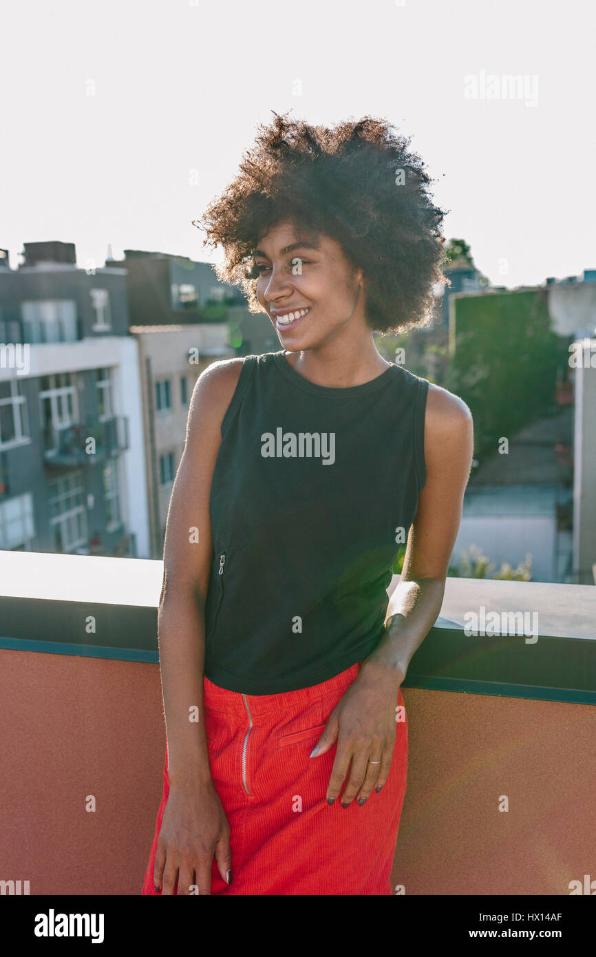 Relaxed woman standing on rooftop in Brooklyn Stock Photo - Alamy