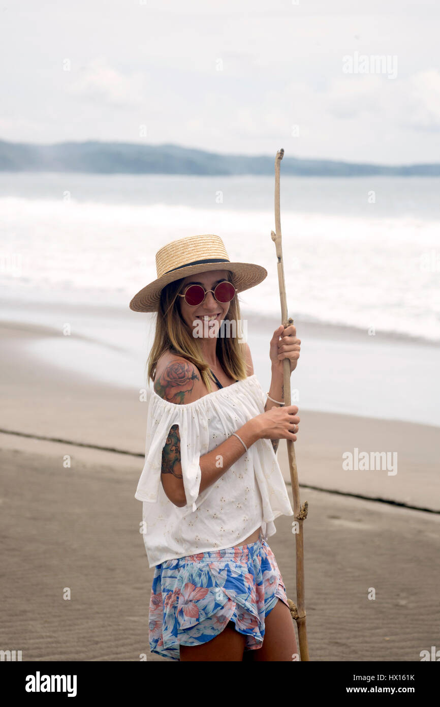 Indonesia, Java, portrait of smiling woman standing on the beach Stock ...