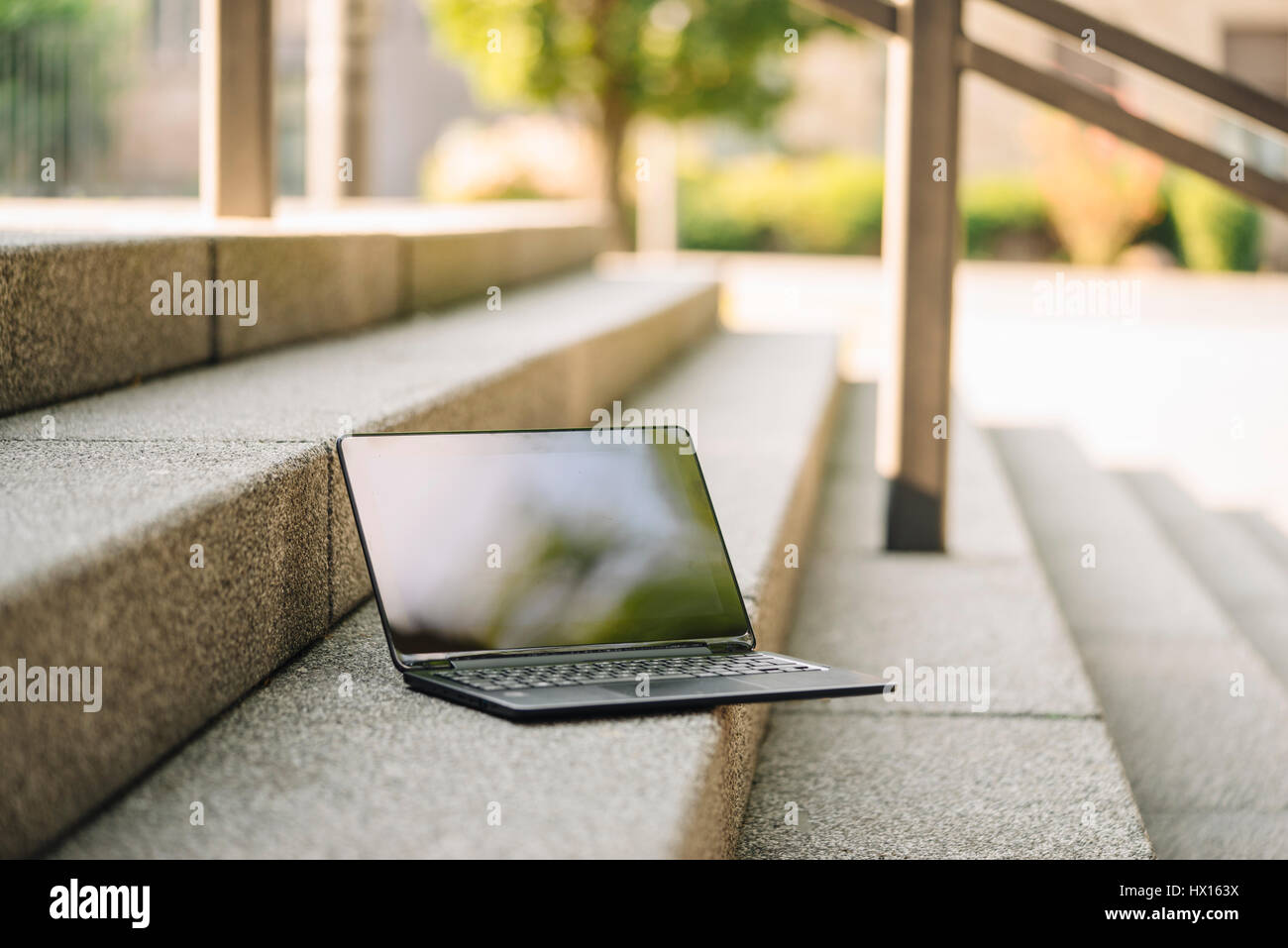 Laptop on stairs Stock Photo - Alamy