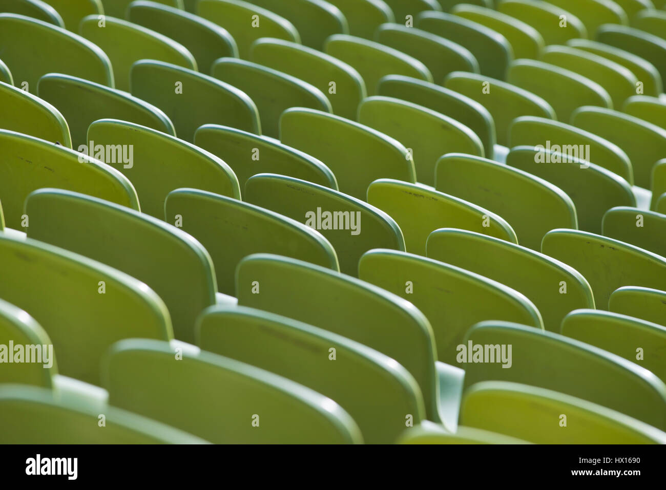 Rows of green seats in a stadium Stock Photo - Alamy