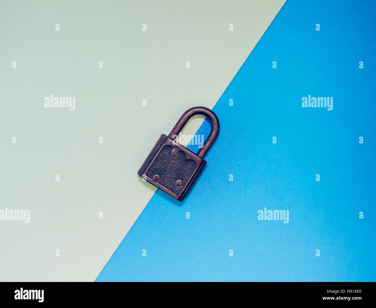 Old little padlock on a colorful blue pastel background Stock Photo - Alamy