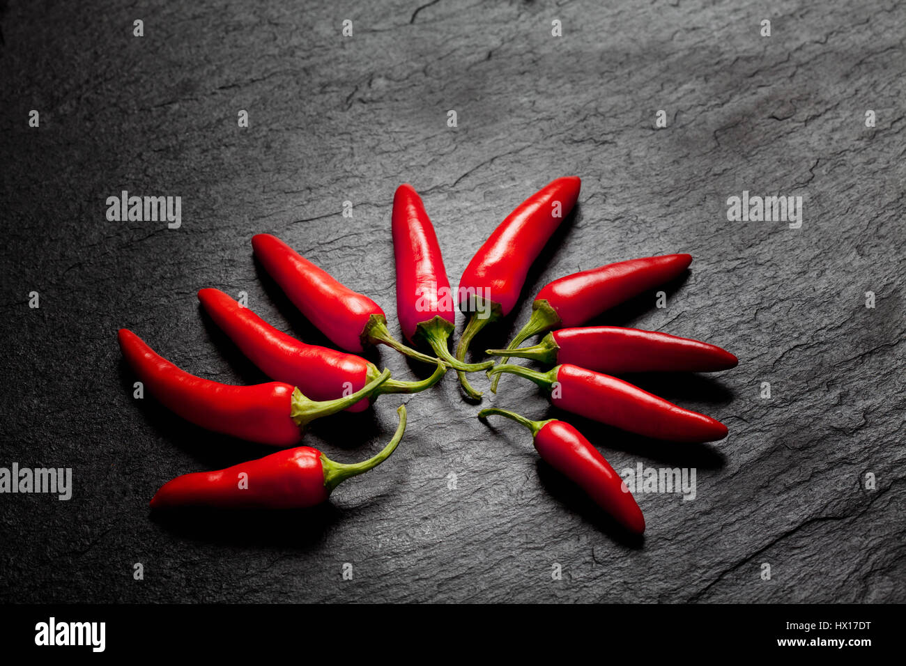 Red chili pods on slate Stock Photo - Alamy