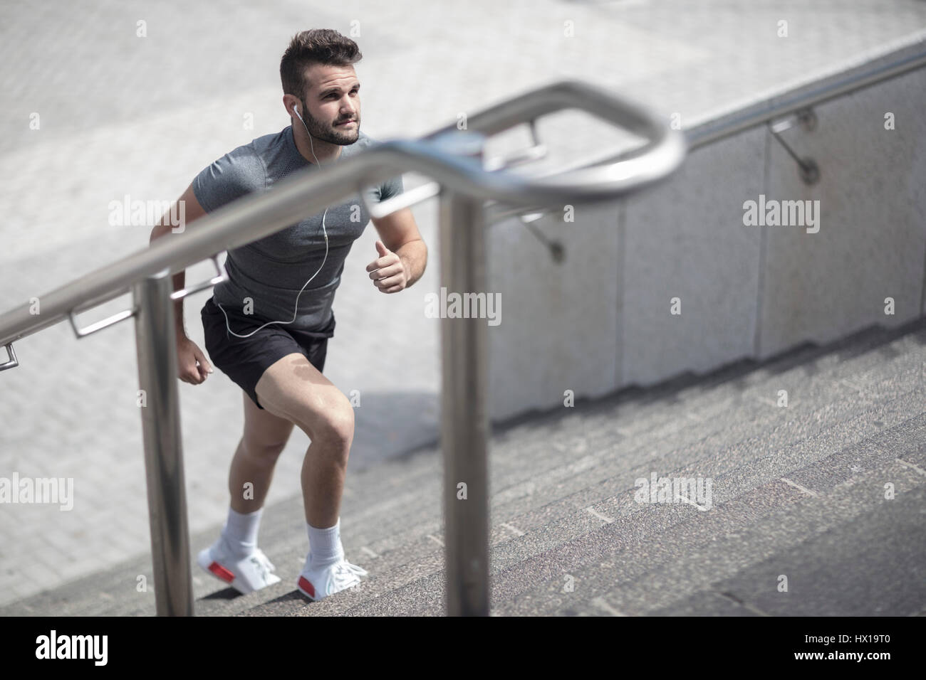 Athlete walking up stairs in the city Stock Photo - Alamy