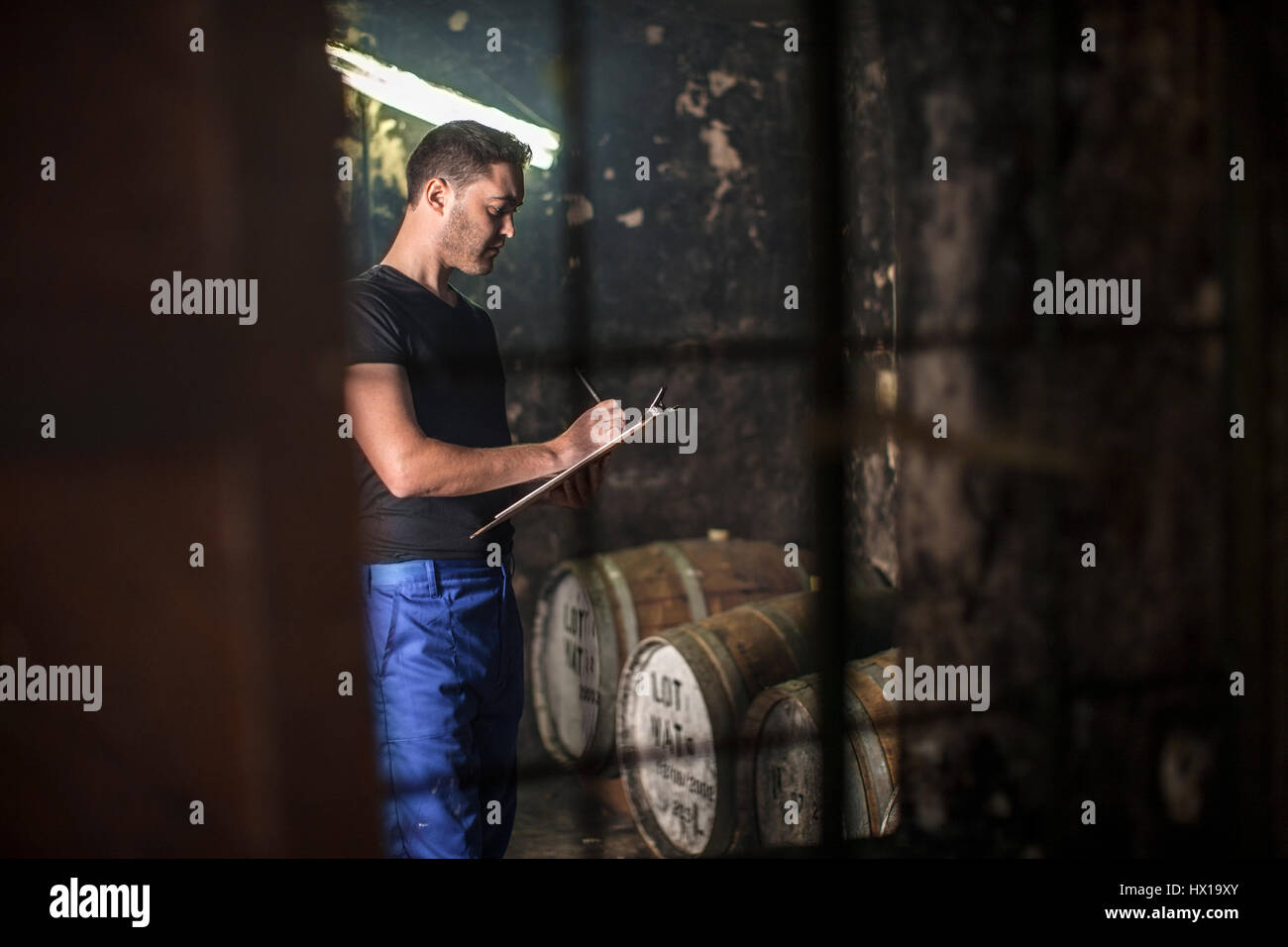 Worker working in distillery Stock Photo - Alamy