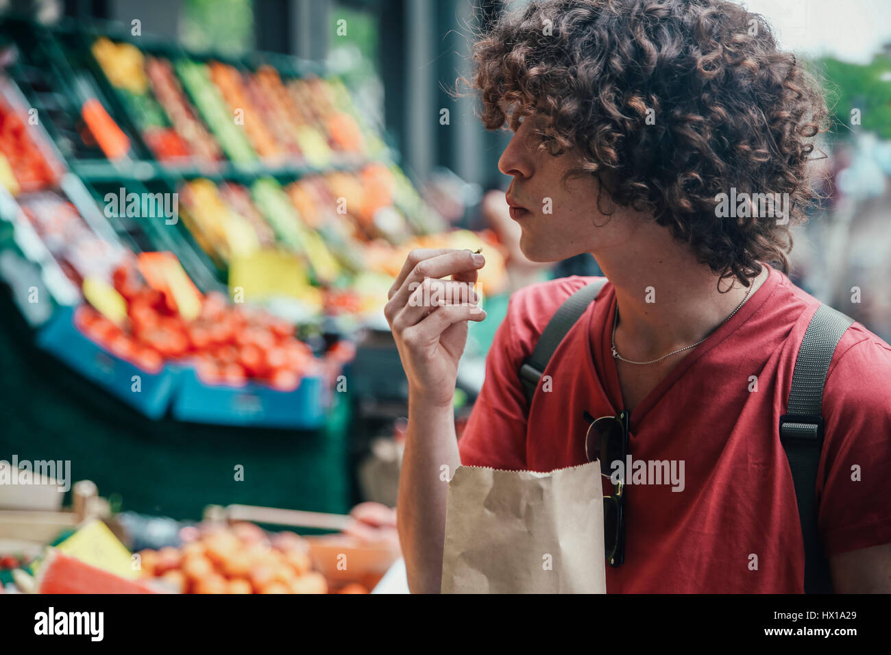Young man eating cherries in hi-res stock photography and images - Alamy