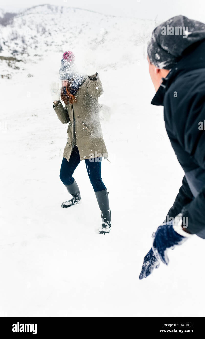 Two women and a man having fun in snow hi-res stock photography and ...