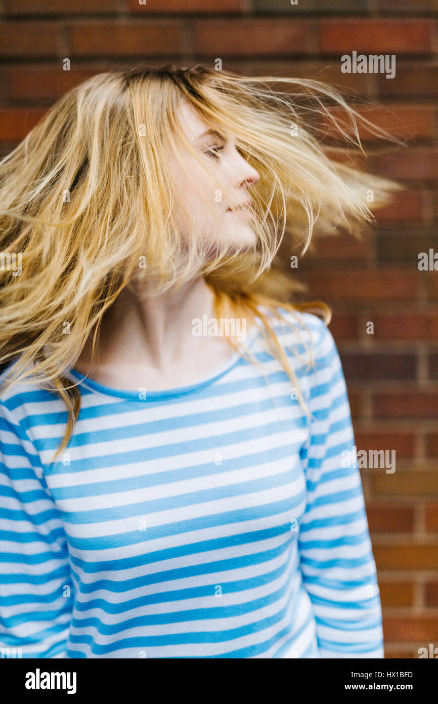 Young woman tossing her hair Stock Photo - Alamy