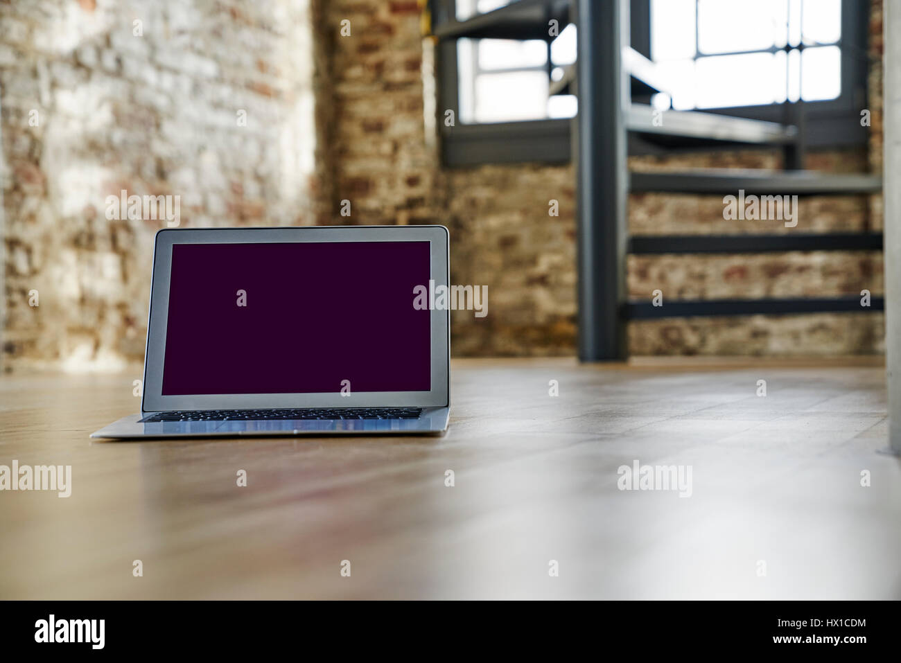 Laptop in empty room Stock Photo - Alamy