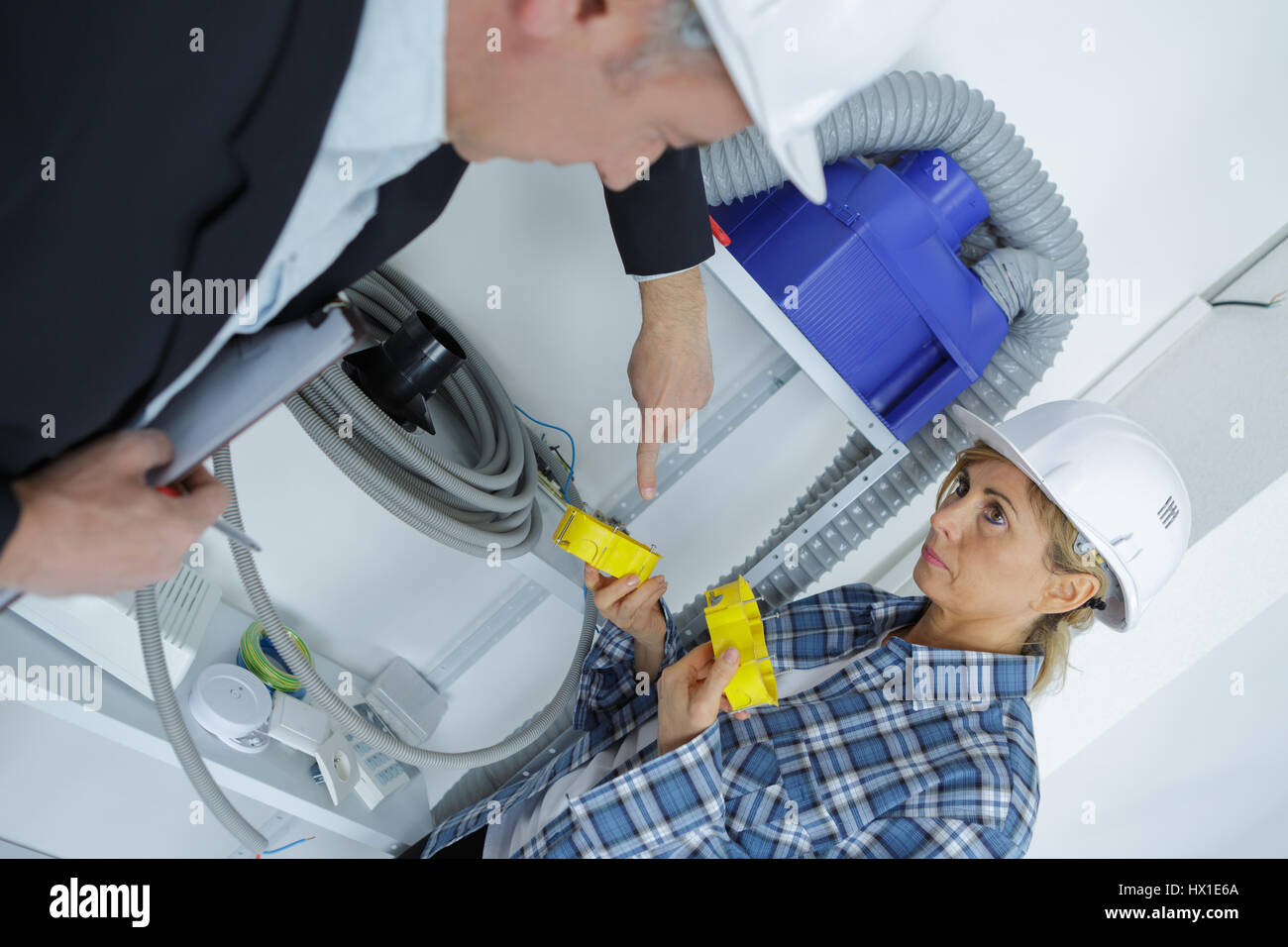women receiving describes air conditioning from man Stock Photo - Alamy