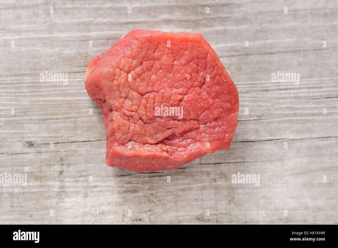 piece of raw beef meat on white wood or stone background Stock Photo ...