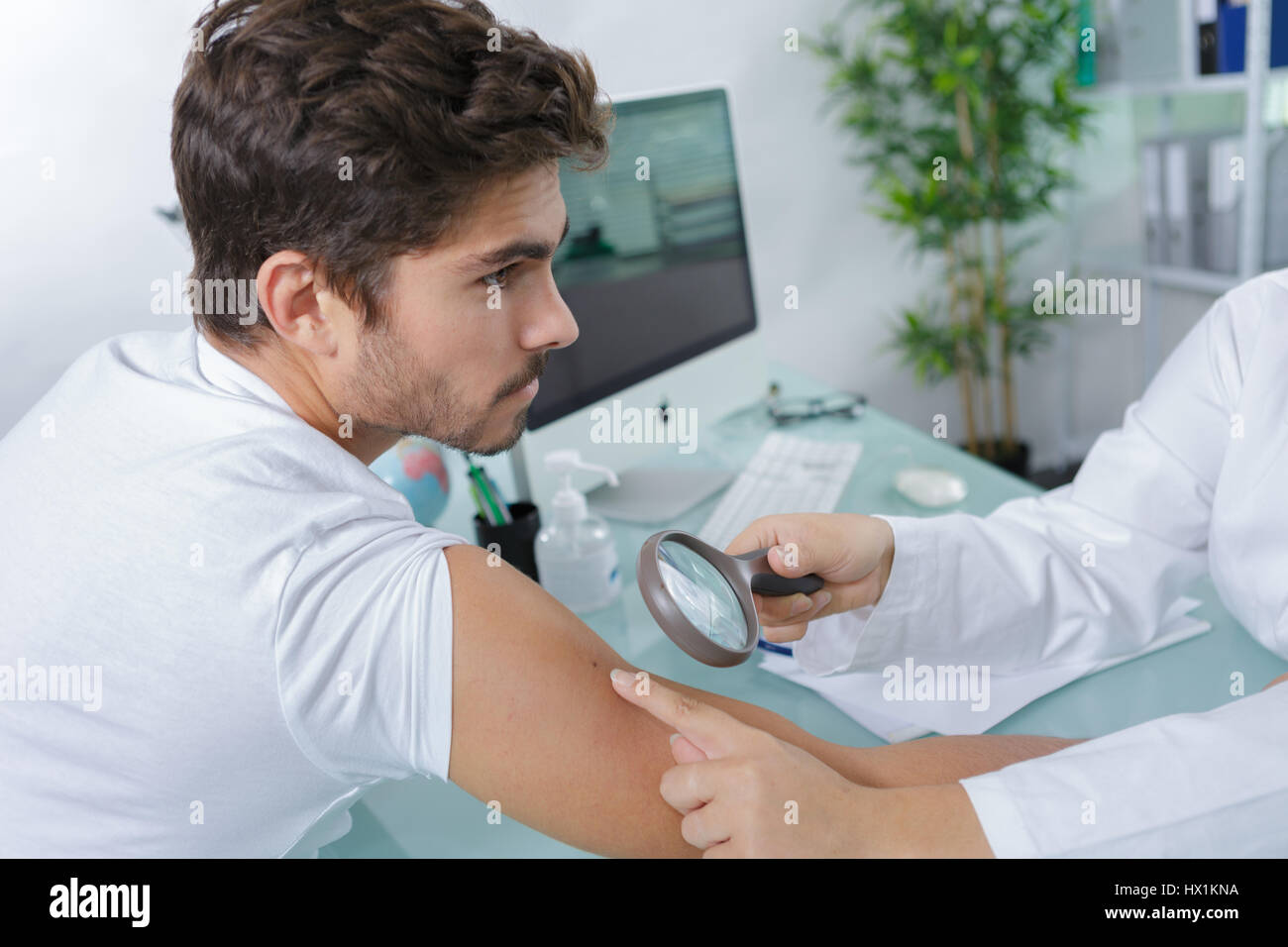 close-up of doctors hands checking mans moles Stock Photo - Alamy