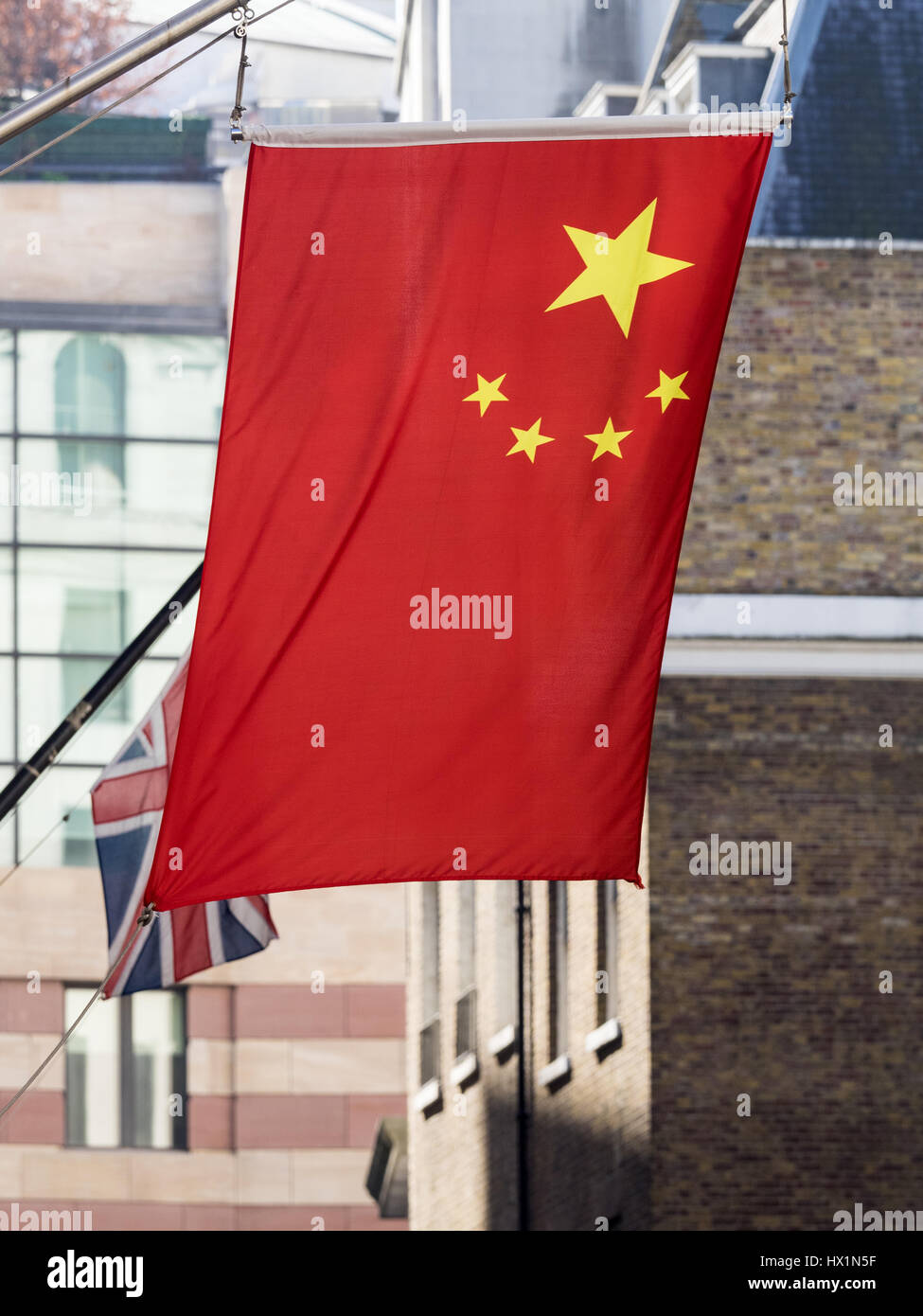 A Chinese flag flies next to the Union Jack flag, outside the Bank of ...