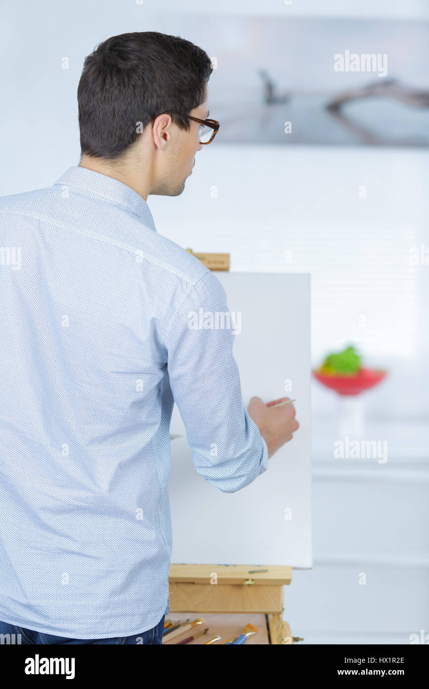artist sitting in his studio working on oil painting Stock Photo - Alamy