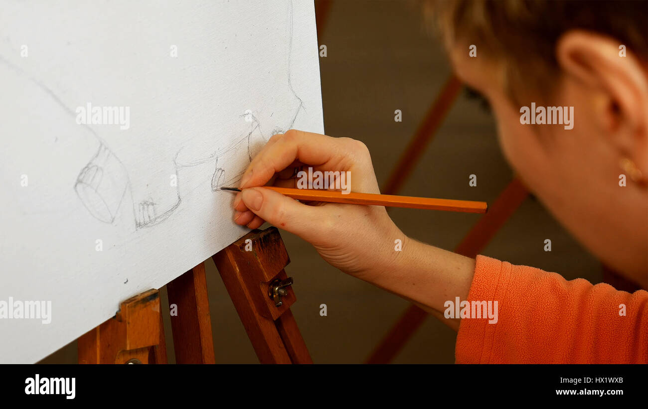 Female artist draws a pencil sketch in art studio Stock Photo - Alamy