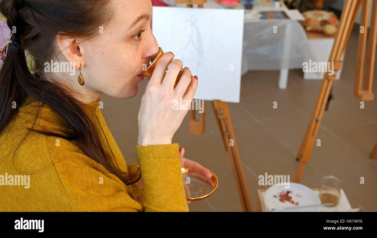Graphic artist having a snack break drinking tea Stock Photo - Alamy
