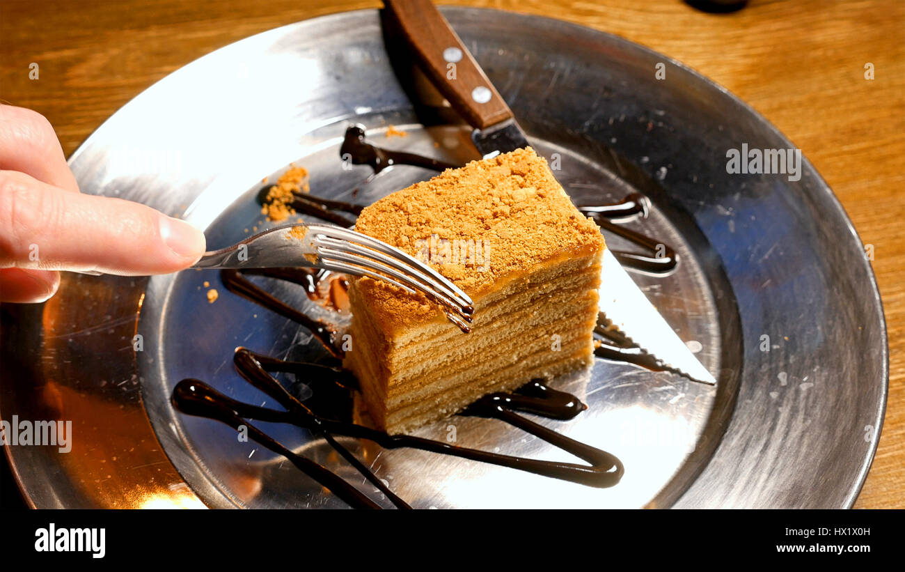 Cake being cut with fork and knife Stock Photo - Alamy