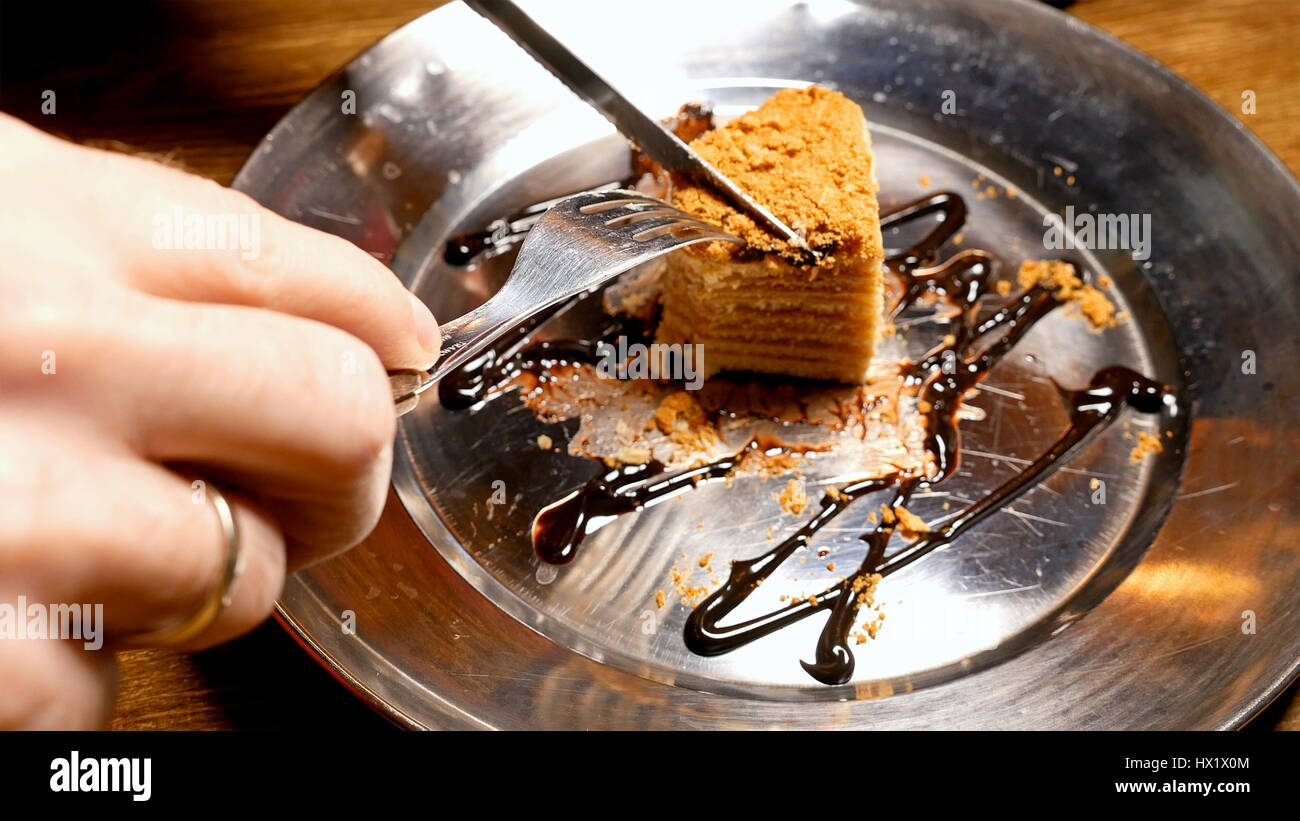 Cake being cut with fork and knife Stock Photo - Alamy