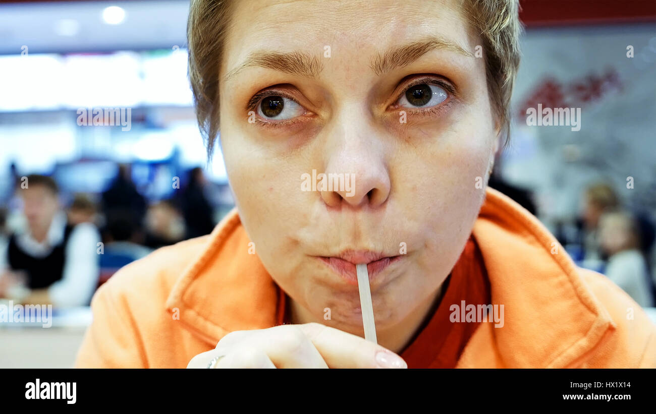 Young woman drinks cola in fast food restaurant Stock Photo - Alamy