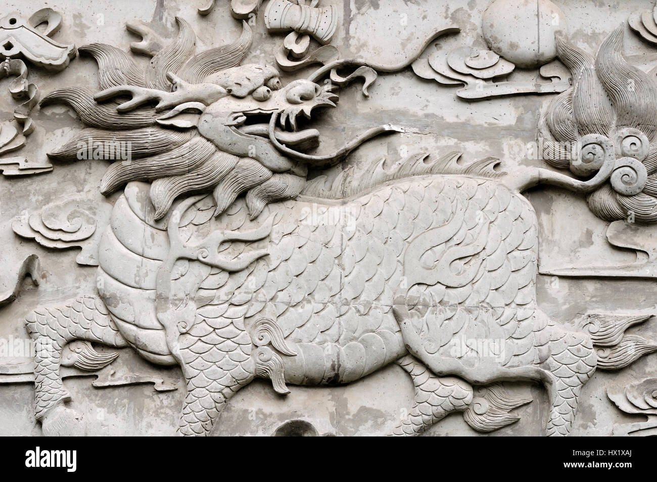 A chinese mythical creature called a kylin on a wall within Shanghai ...