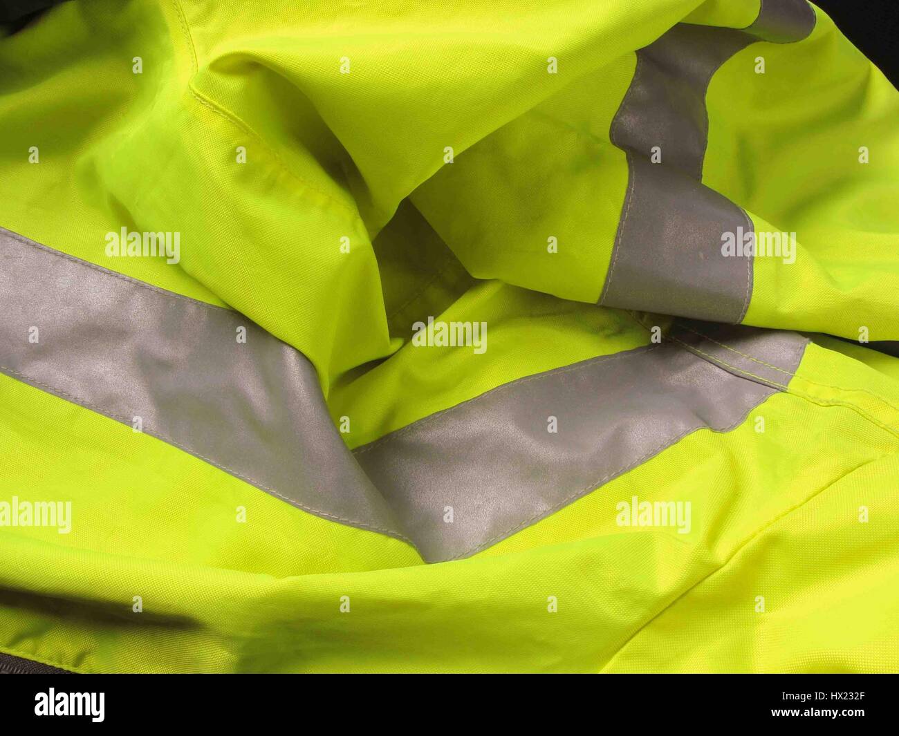 high visibility yellow jacket as background Stock Photo - Alamy