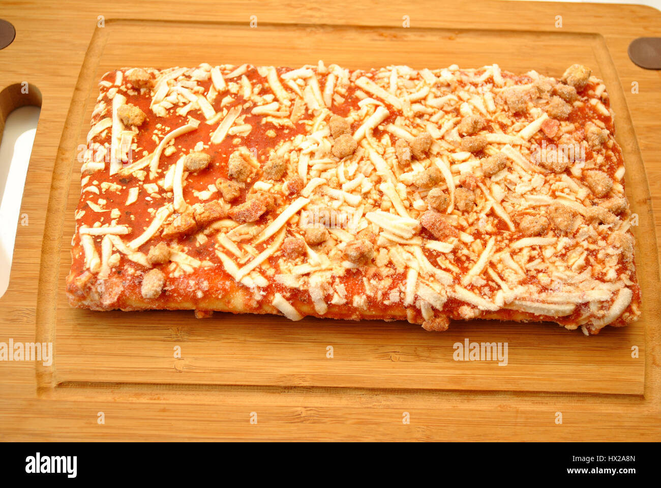 A Slice of Square Frozen Cheese & Meat Pizza Stock Photo - Alamy