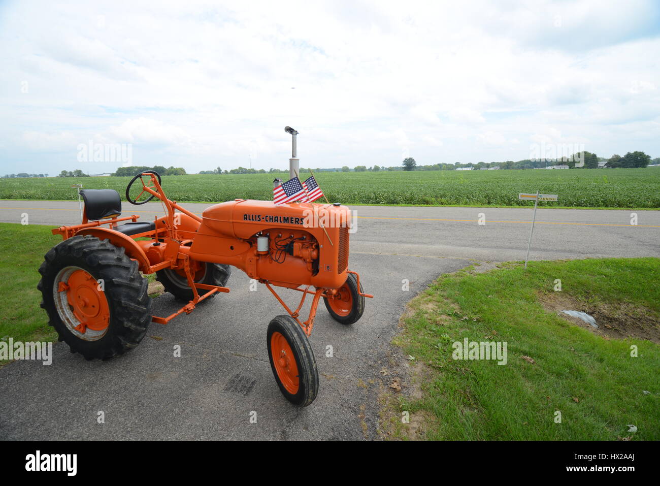 old retro orange tractor Stock Photo - Alamy