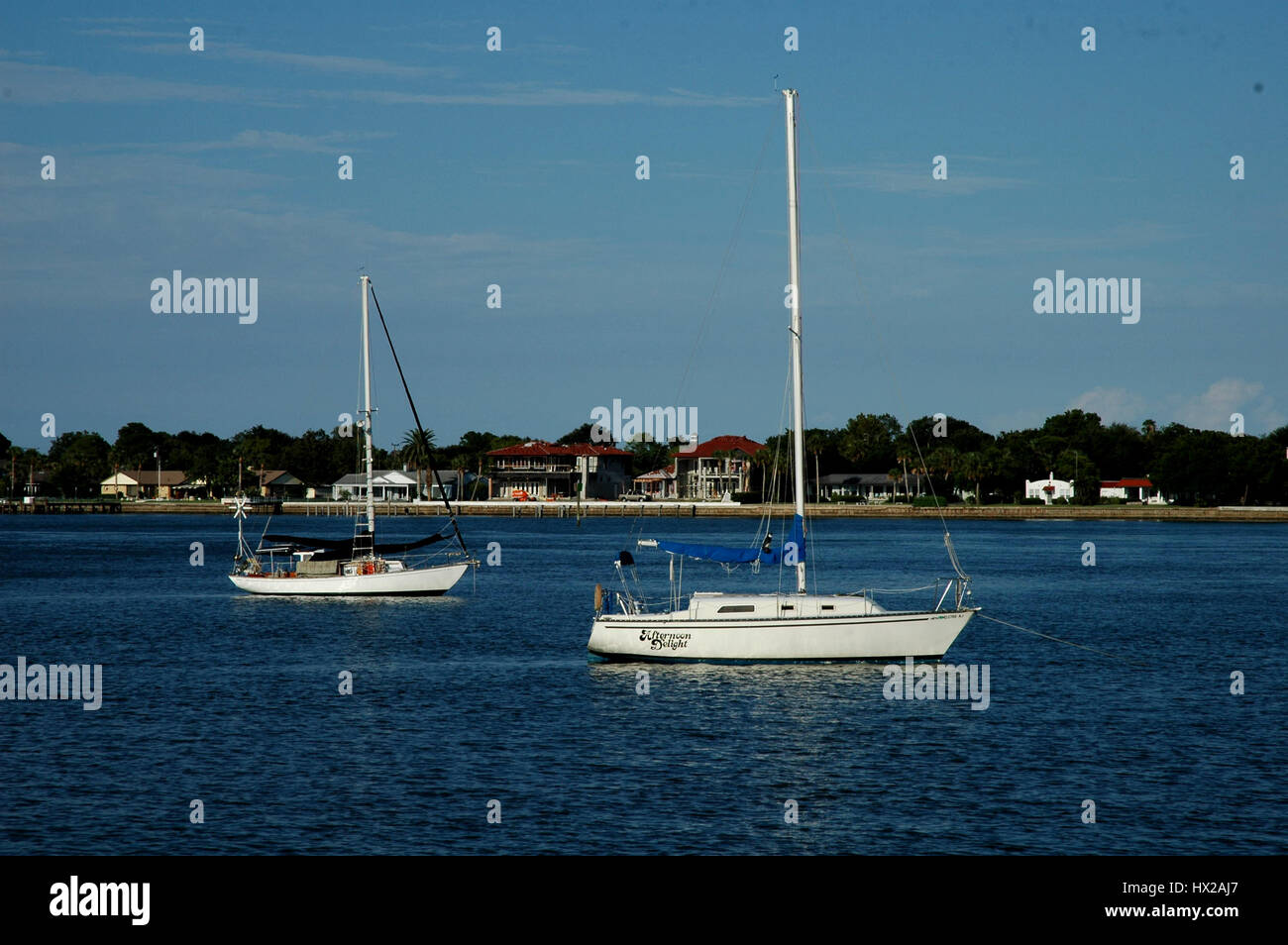two sailboats anchored in bay Stock Photo - Alamy