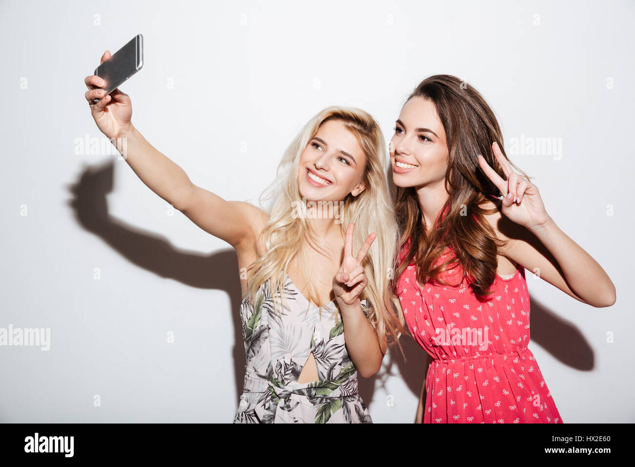 Happy woman friends smartphone victory hi-res stock photography and ...