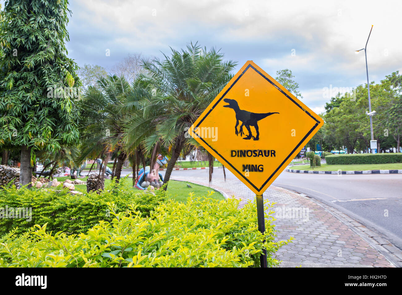 Yellow traffic label with dinosaur pictogram Stock Photo - Alamy