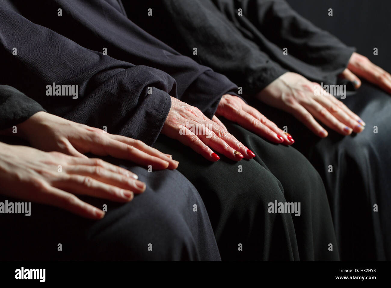 Hands together on knees hi-res stock photography and images - Alamy