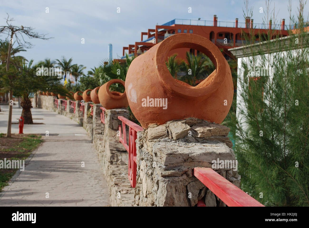 Decorative fence of clay pots, a pedestrian path to the beach in the ...