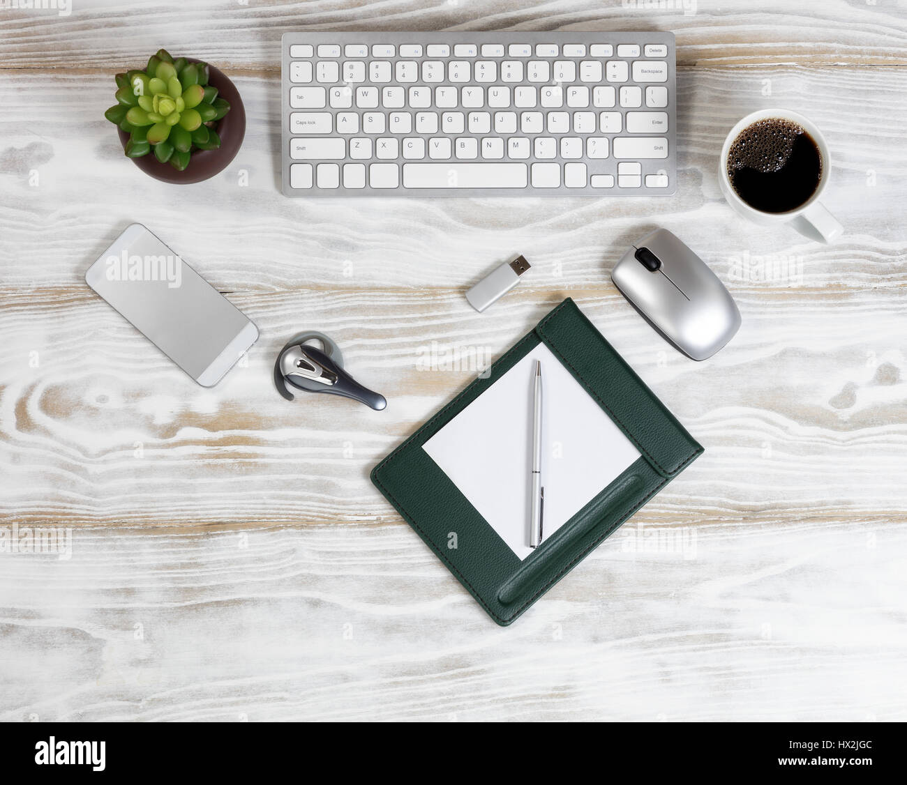 Overhead view of a modern technology devices on white wooden desktop ...