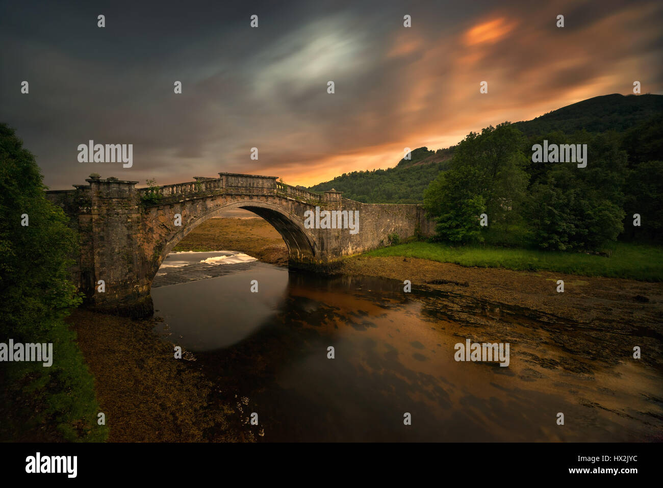 Garron Bridge over the Gearr Abhainn river in sunset orange light ...